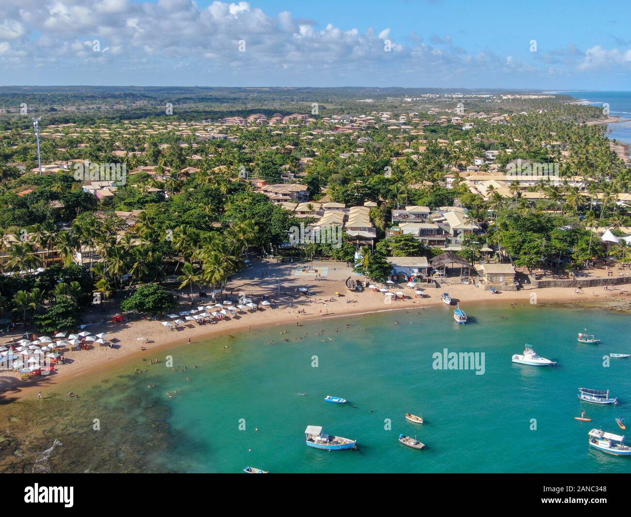 Aerial view of Praia Do Forte coastline village with beach and blue ...