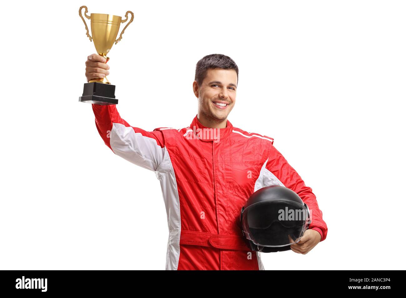 Young male car racer standing and holding a helmet and a gold trophy ...