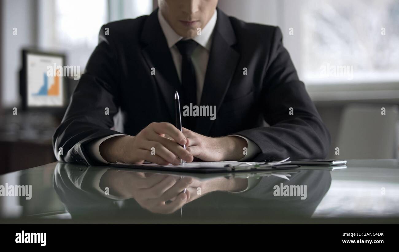 Company director thinking seriously on document, difficult business ...