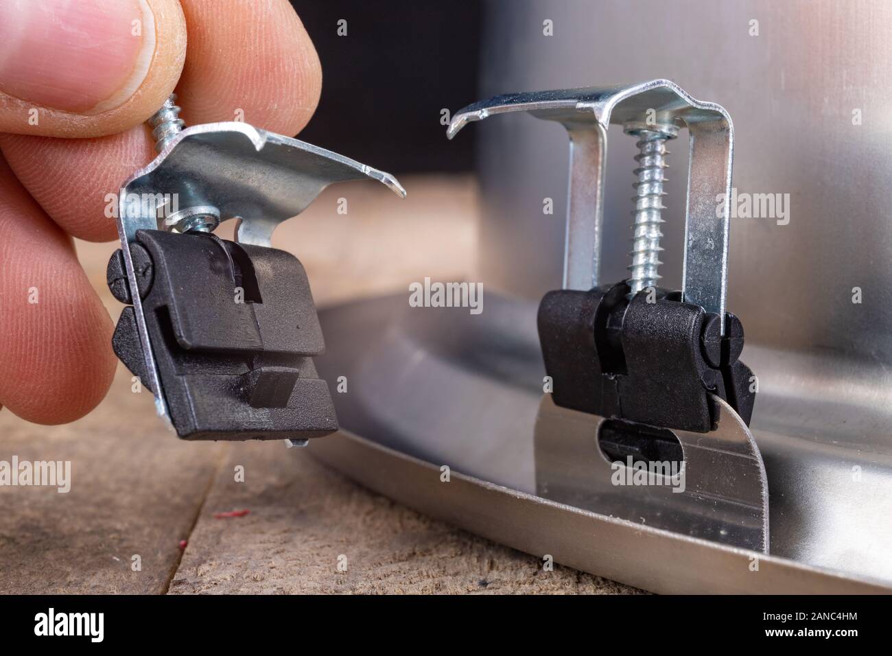 Hook for mounting a metal sink in a kitchen counter. Installation of ...