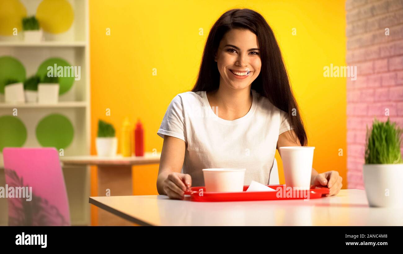 Female customer with plastic tray smiling, dinner in fast food ...