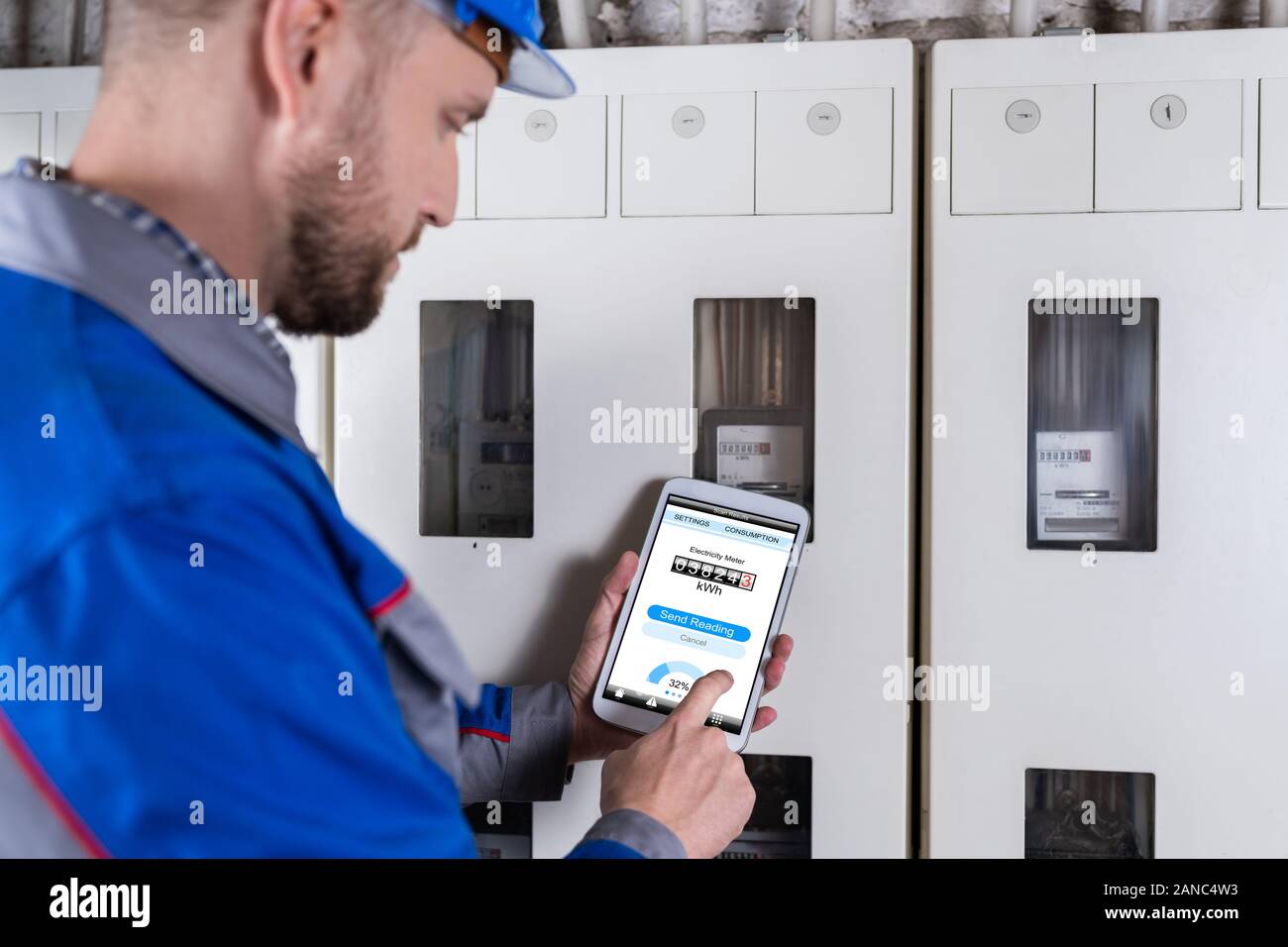 Male Technician Doing Meter Reading Using Tablet Stock Photo - Alamy
