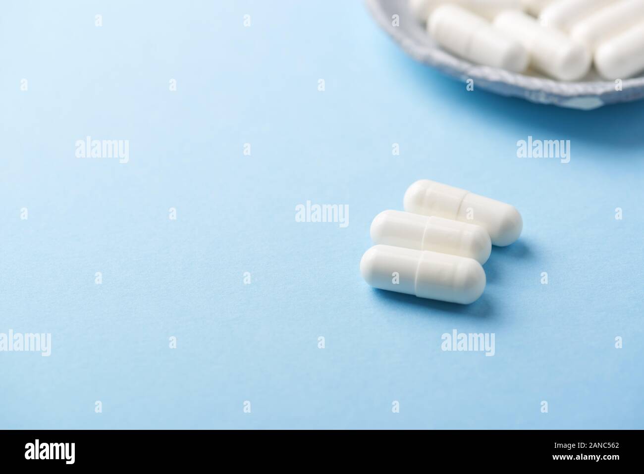 Leucine amino acid. Fitness supplement on bright paper background ...