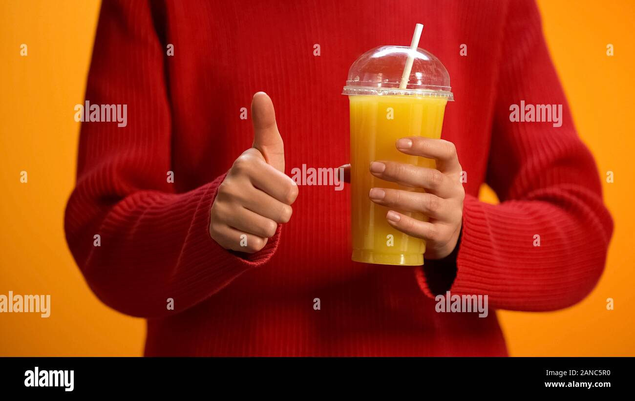 Lady with orange juice, hand showing thumbs up, healthy citrus cocktail ...