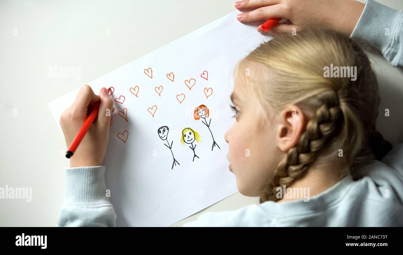 Little girl painting family with heart signs, orphan dreaming about ...
