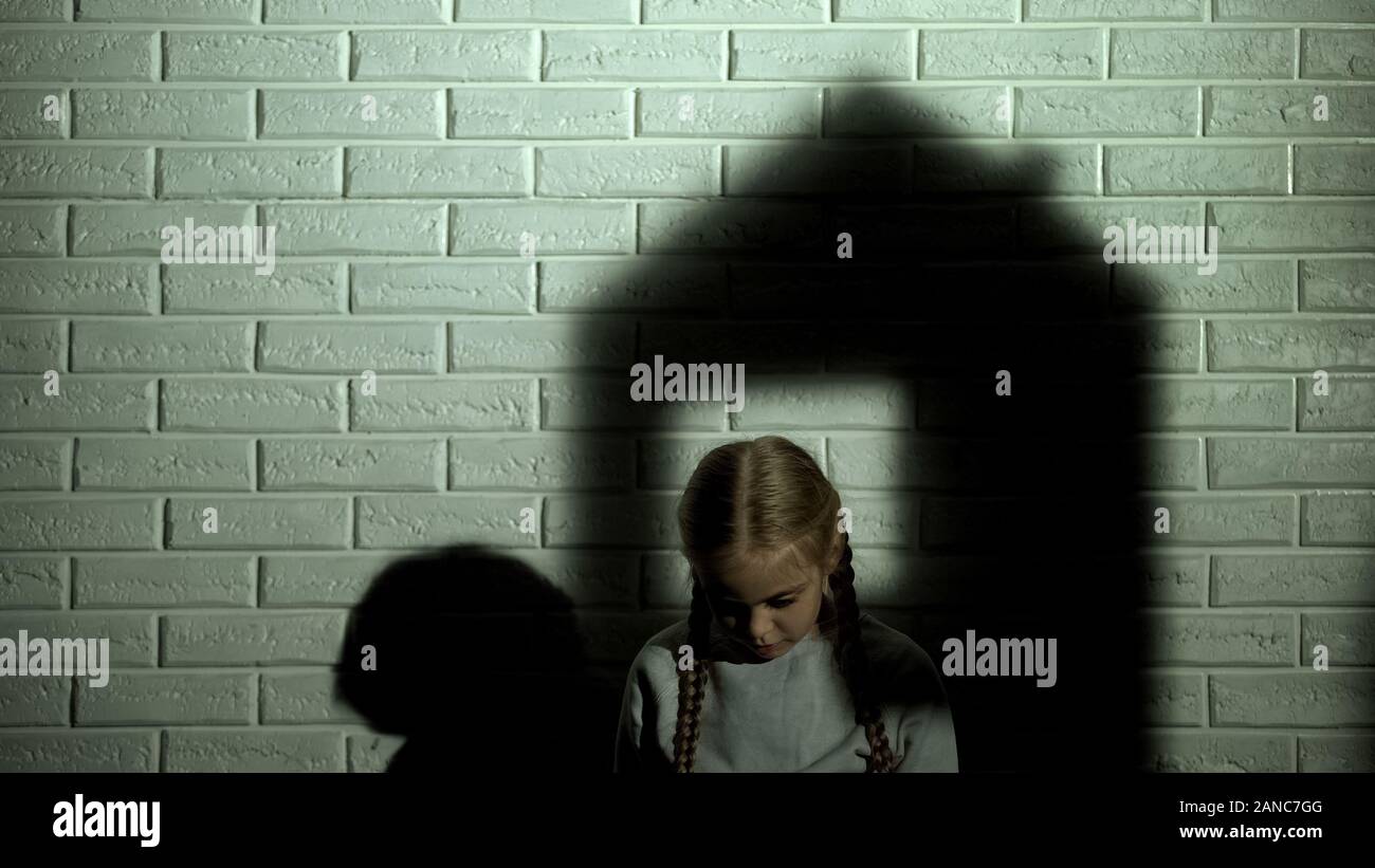 House shadow on wall behind little girl, orphan child needs home and ...
