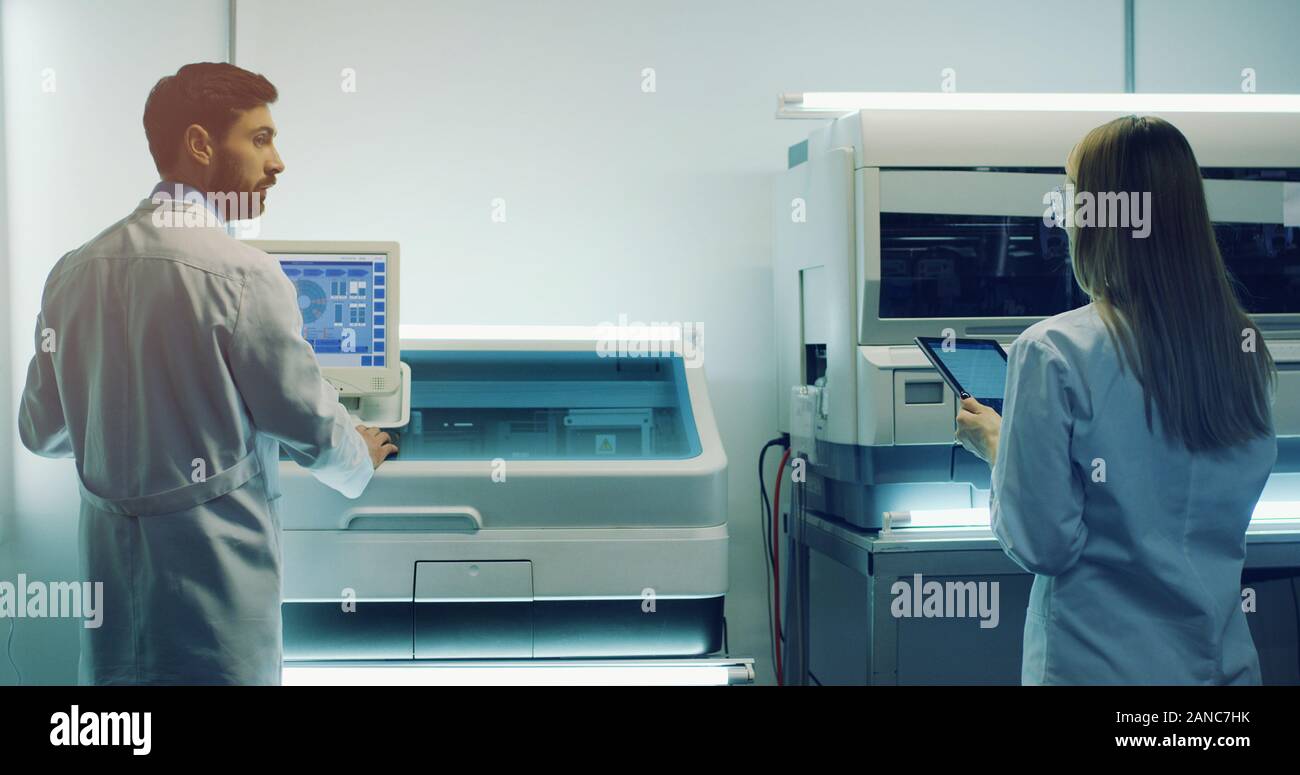 Scientists working using microscope hi-res stock photography and images ...