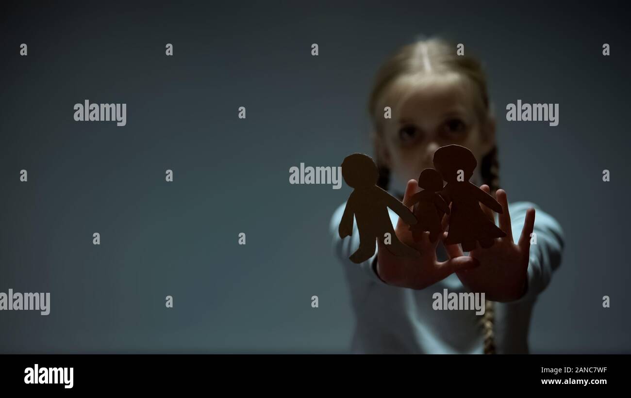 Child showing paper family into camera, orphan child missing lost ...