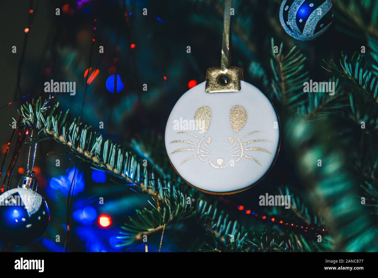 White gingerbread with the symbol of the year 2020 rat. Christmas tree ...