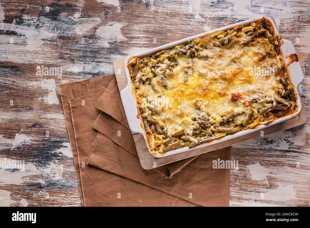 Baked vegetable lasagna with green beans and cheese in a ceramic bowl ...