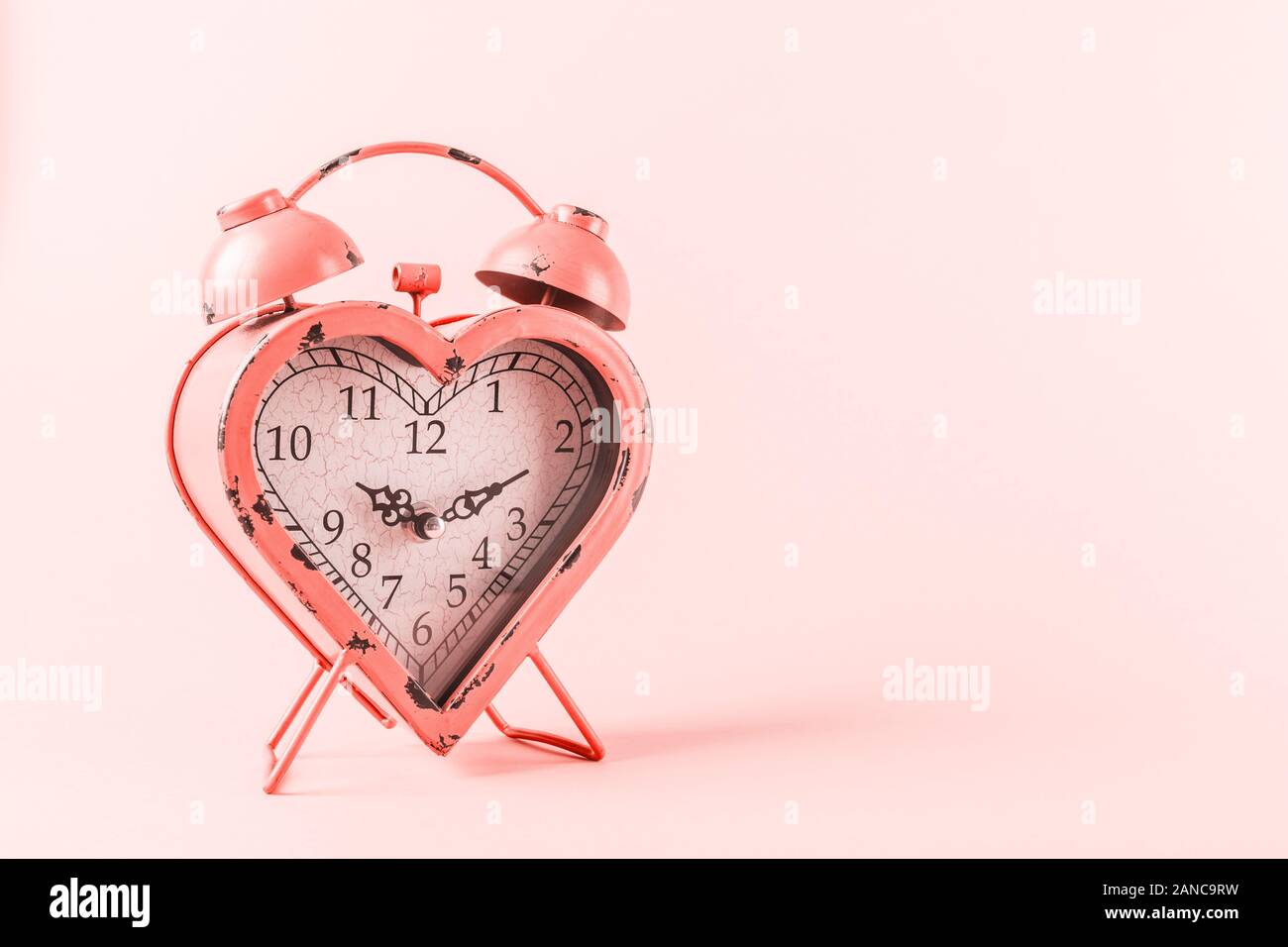 Heart shaped clock on pink background. Valentines day and love infitity ...
