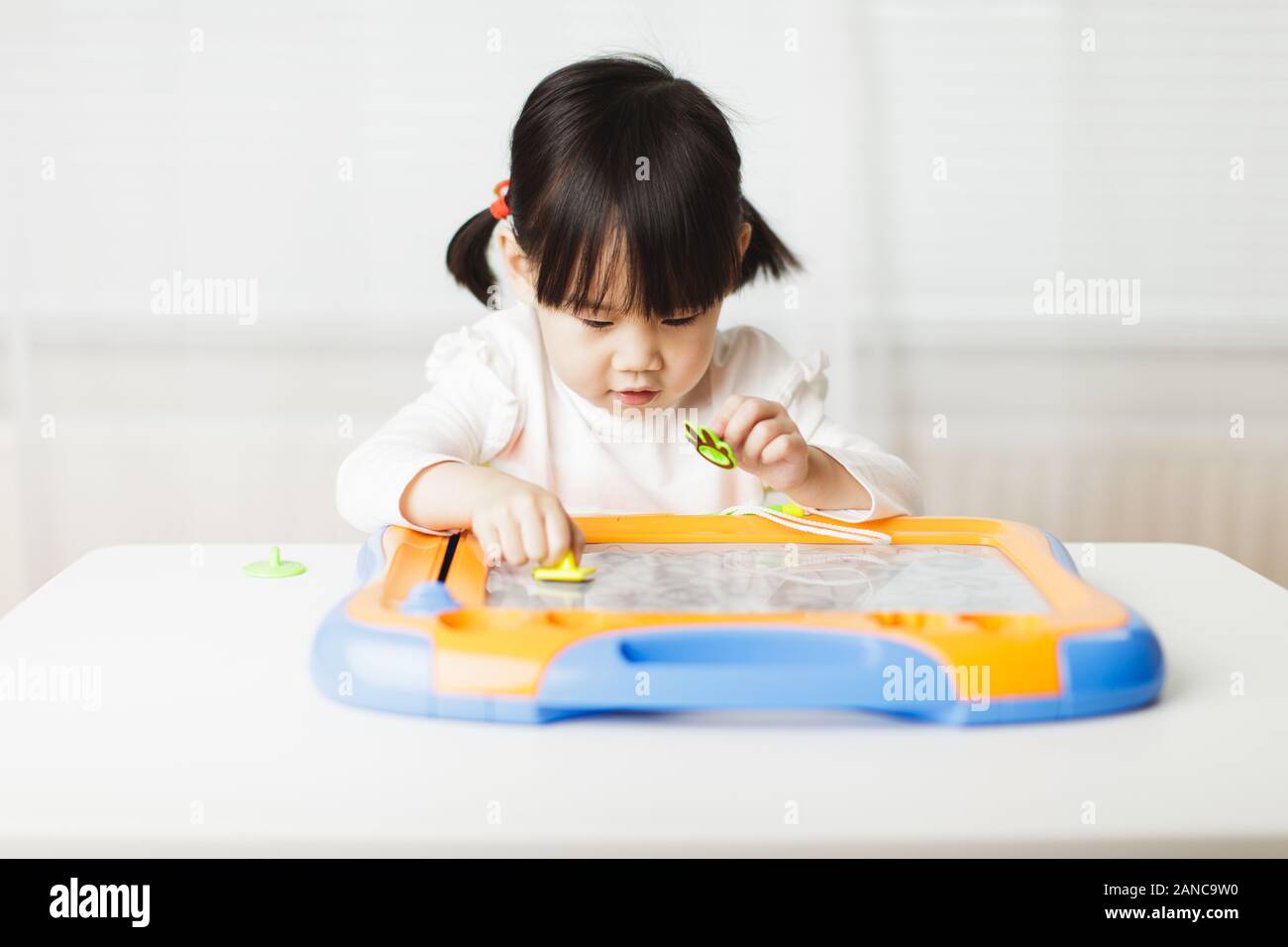 toddler girl learn drawing at home against white background Stock Photo ...