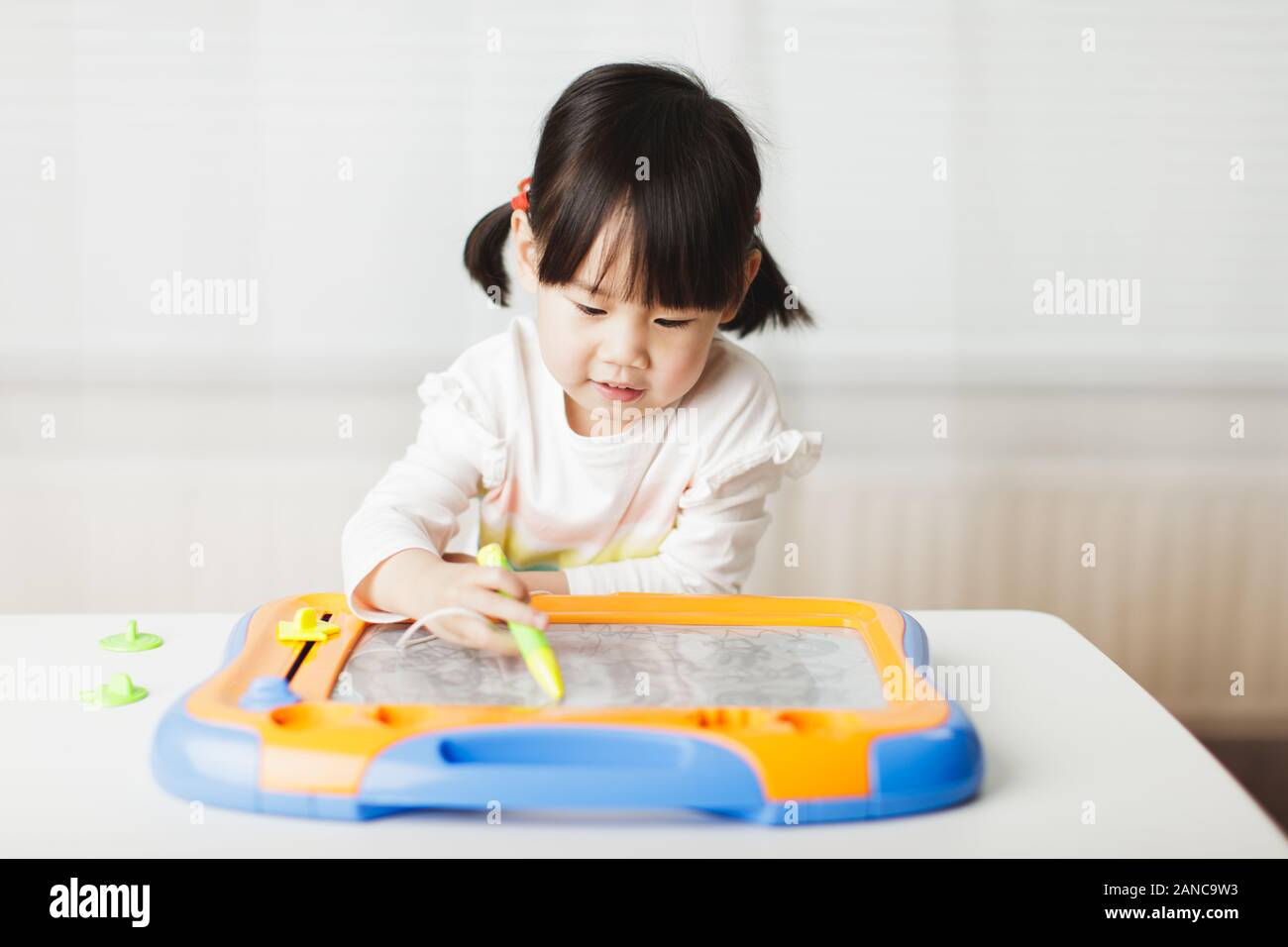 toddler girl learn drawing at home against white background Stock Photo ...