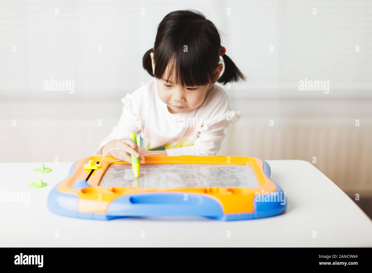 toddler girl learn drawing at home against white background Stock Photo ...