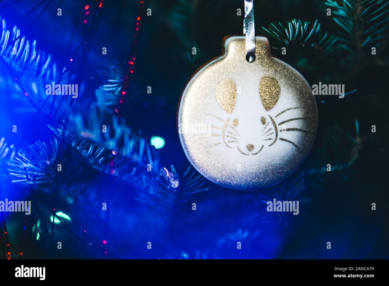 White gingerbread with the symbol of the year 2020 rat. Christmas tree ...