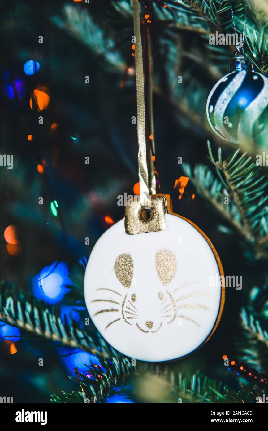 White gingerbread with the symbol of the year 2020 rat. Christmas tree ...