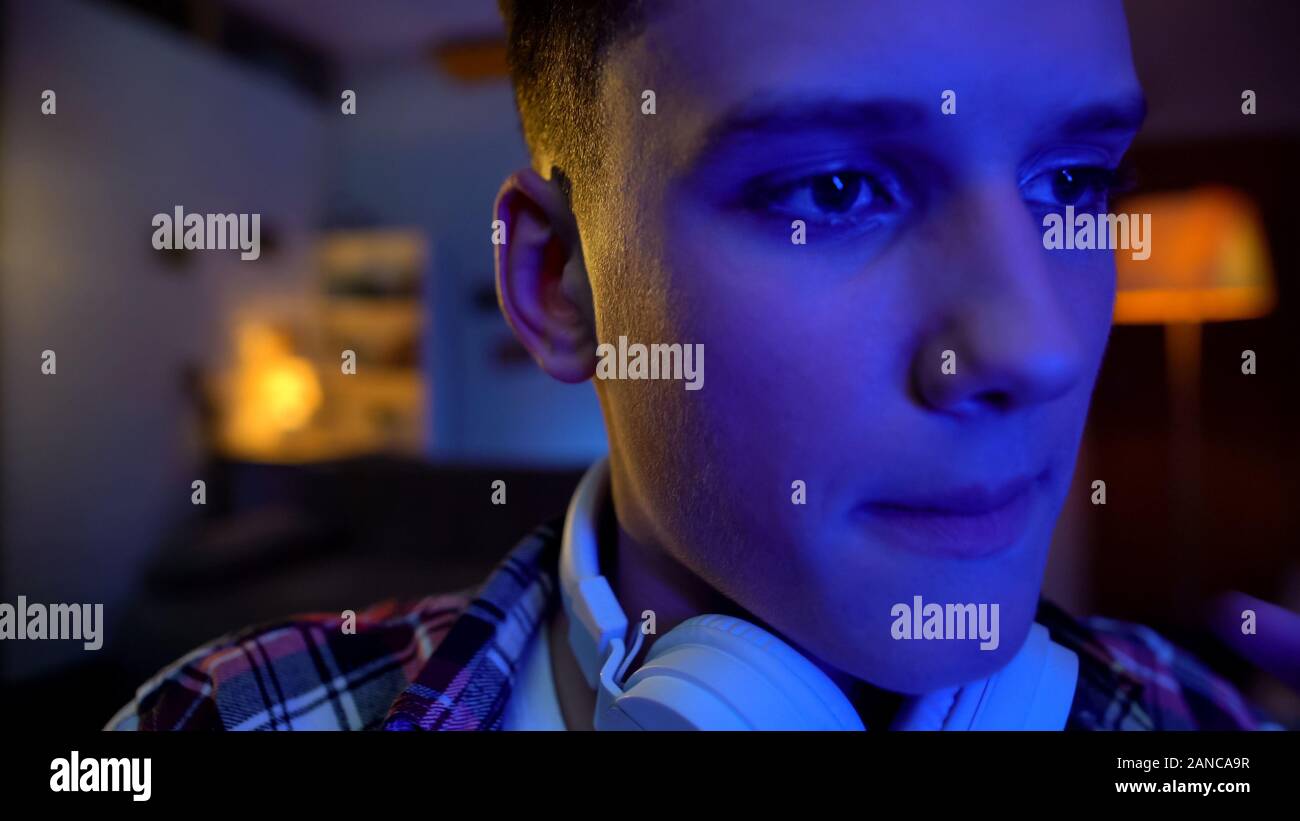 Teenage boy playing video game late at night, harm to sight ...