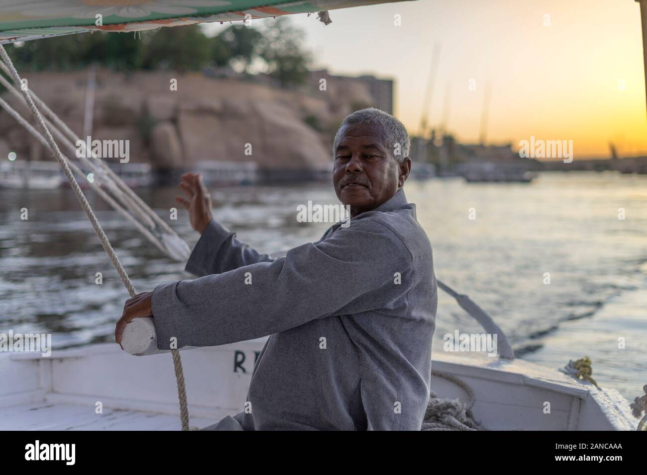 Aswan sail boat captain Stock Photo - Alamy