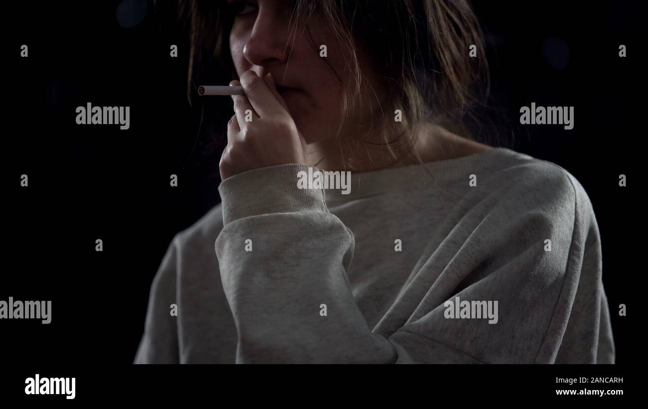 Stressed young woman smoking cigarette, unhealthy habit, addiction ...