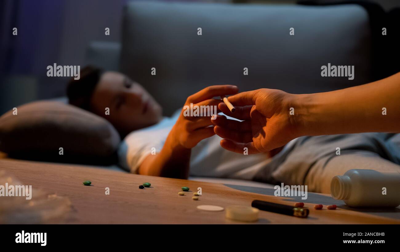 Hand giving cigarette to drug and nicotine addicted teenager, harmful ...