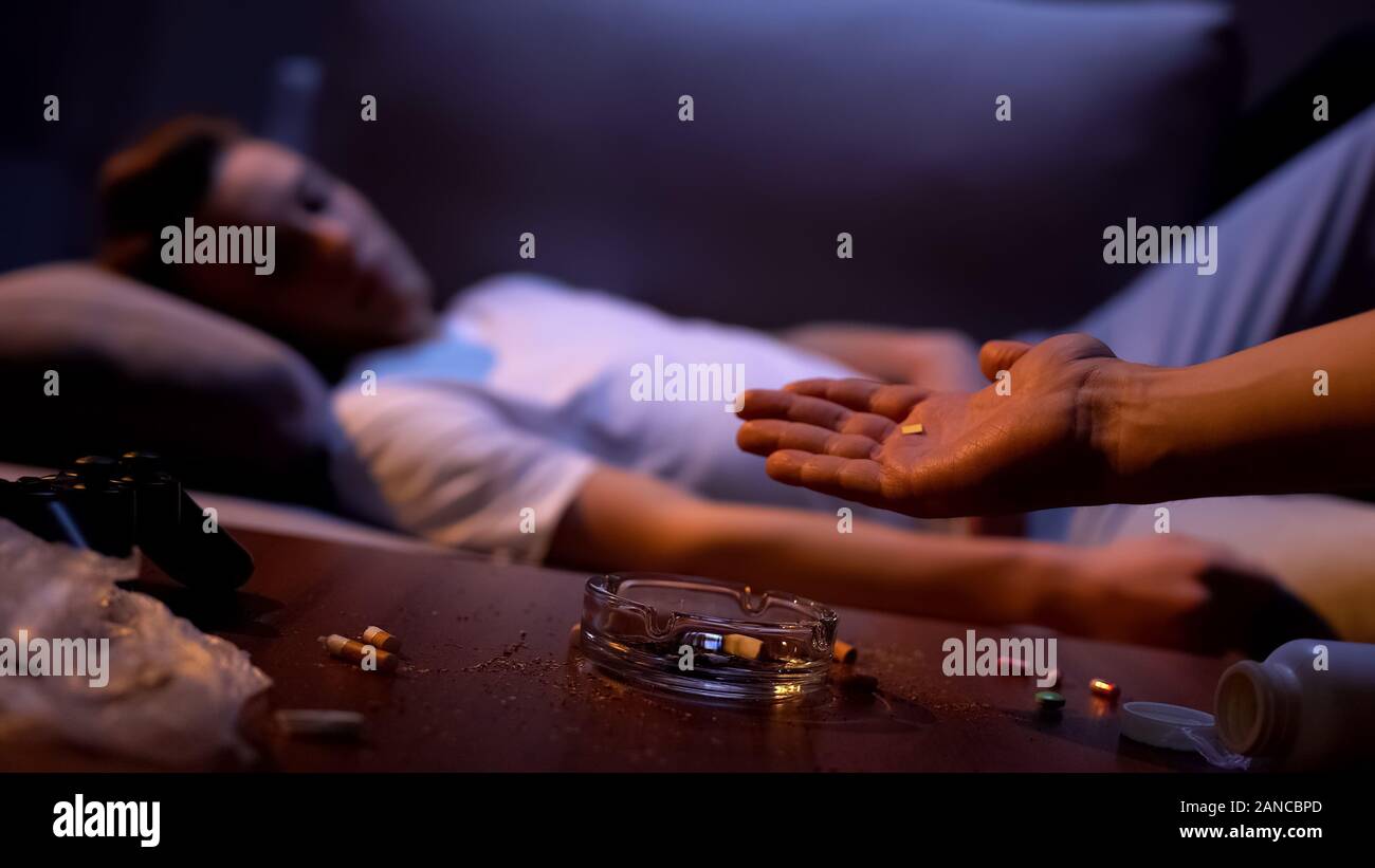 Drug dealer giving addicted teenager LSD blotter, bad influence, club ...