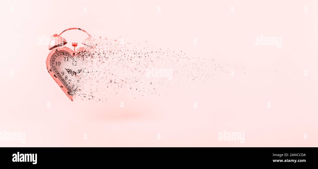 Heart shaped clock dispersing on pink background. Valentines day and ...