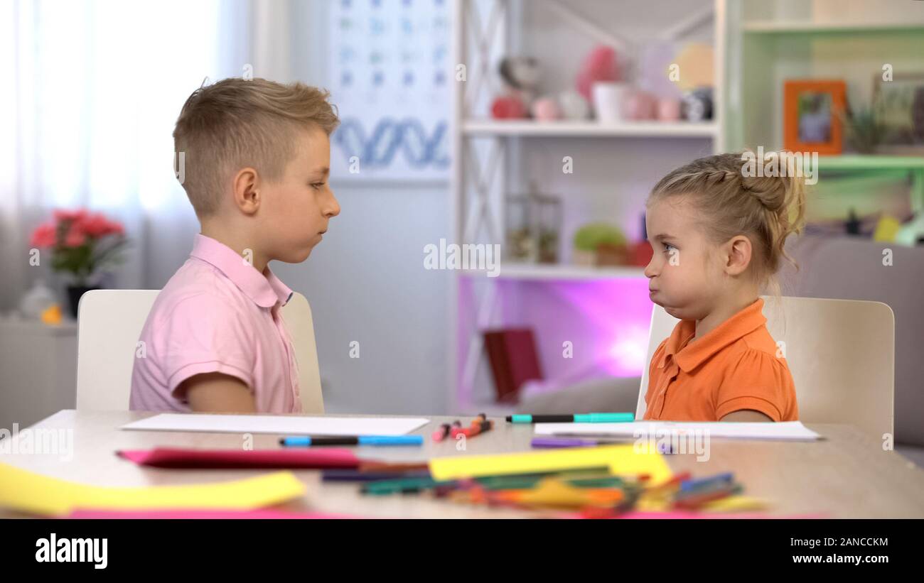 Brother and sister making faces, fooling around, having fun together ...