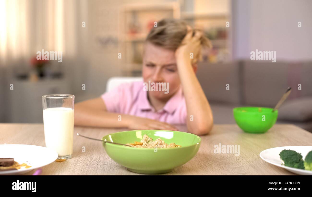 Unhappy caucasian boy looking at dinner hi-res stock photography and ...