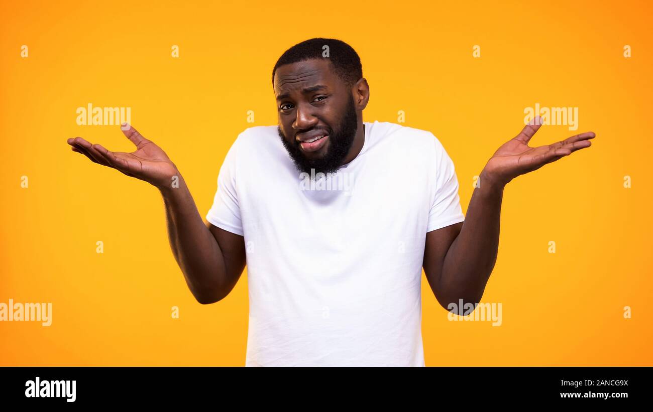 Confused afro-american man showing no idea gesture, problem hesitation ...