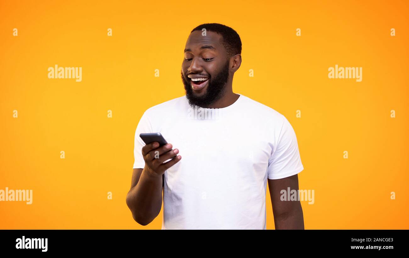 Amazed african man browsing smartphone internet, online application ...