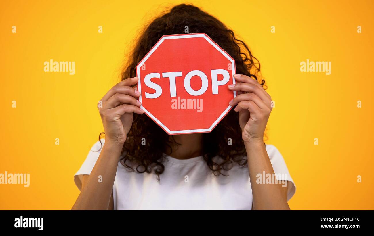 Young woman showing stop sign, protesting against racism and violence ...