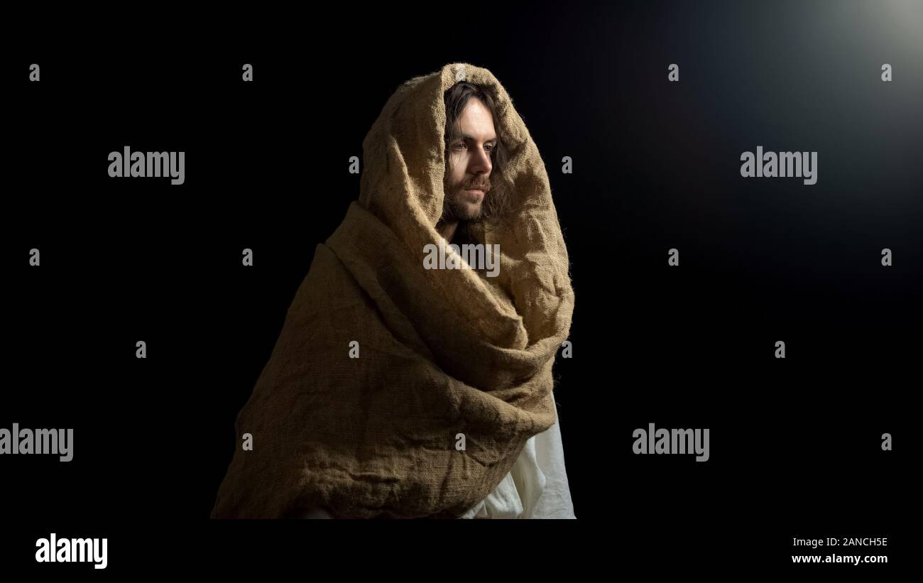 Messiah in robe standing in dark, religion as hope for salvation in ...