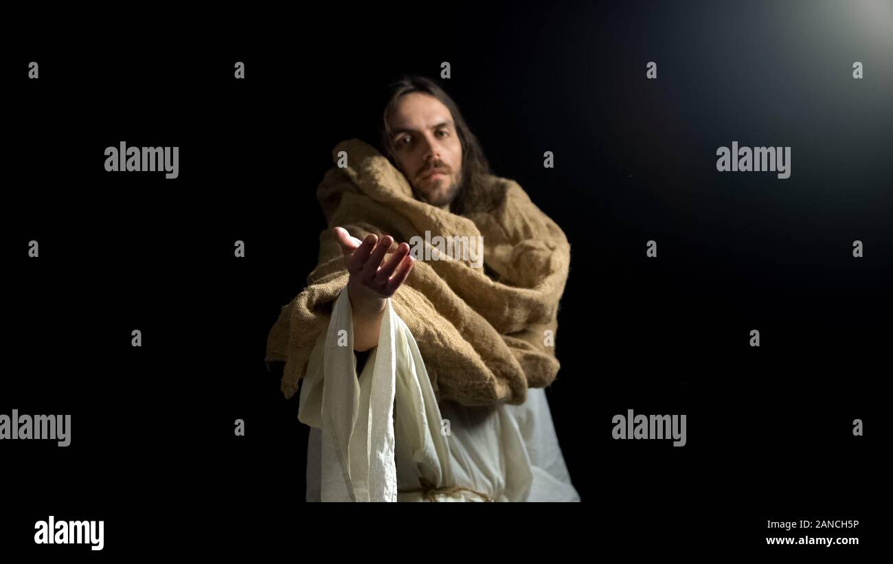 Jesus standing in darkness and giving helping hand, appeal to ...