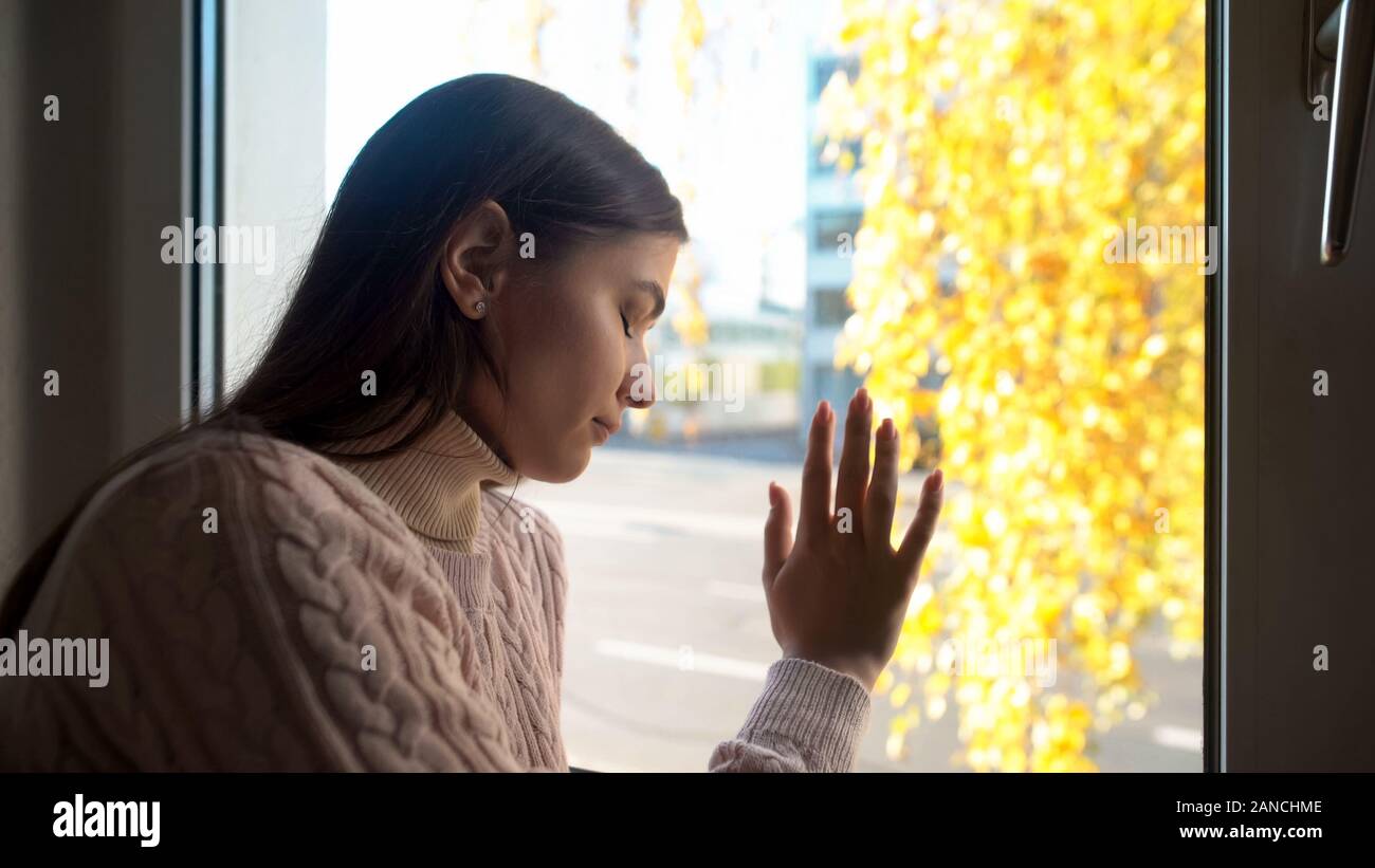Crying woman touching window, felling sorrow and frustration, autumn ...