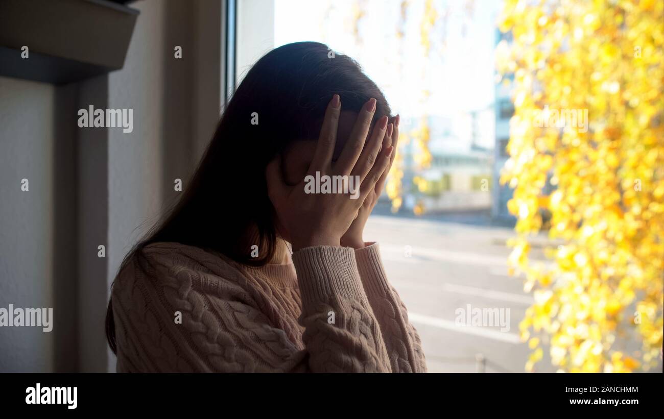 Desperate lady crying and closing face with hands, loss of loved one ...