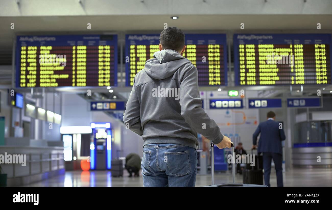 Tourist looking at time table, checking schedule on screen in bus ...