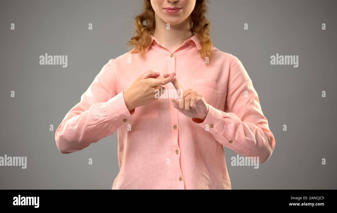Woman saying friend in sign language, showing words in asl lesson ...