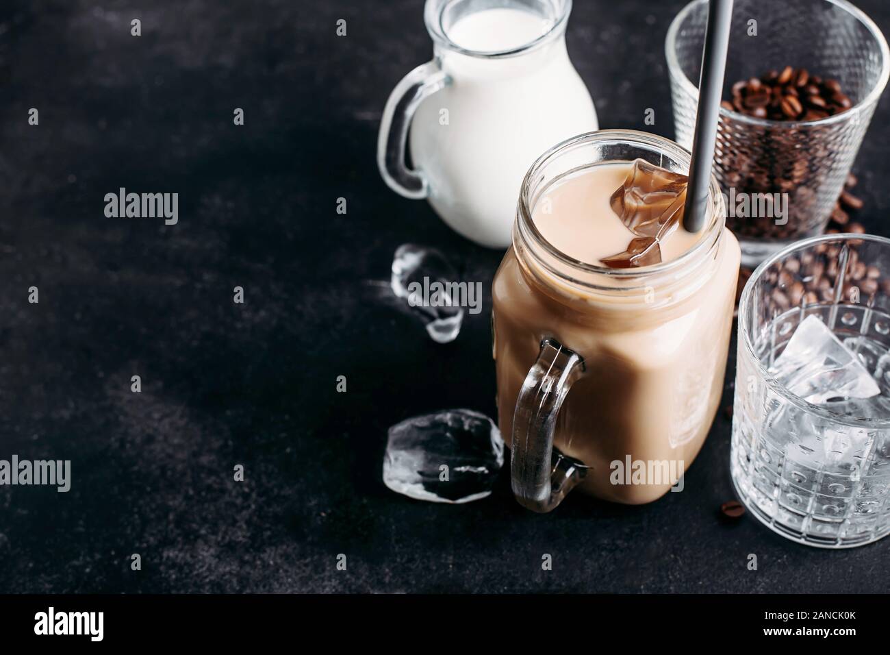 Cold iced coffee with ingredients: ice cubes, milk, coffee beans Stock Photo - Alamy