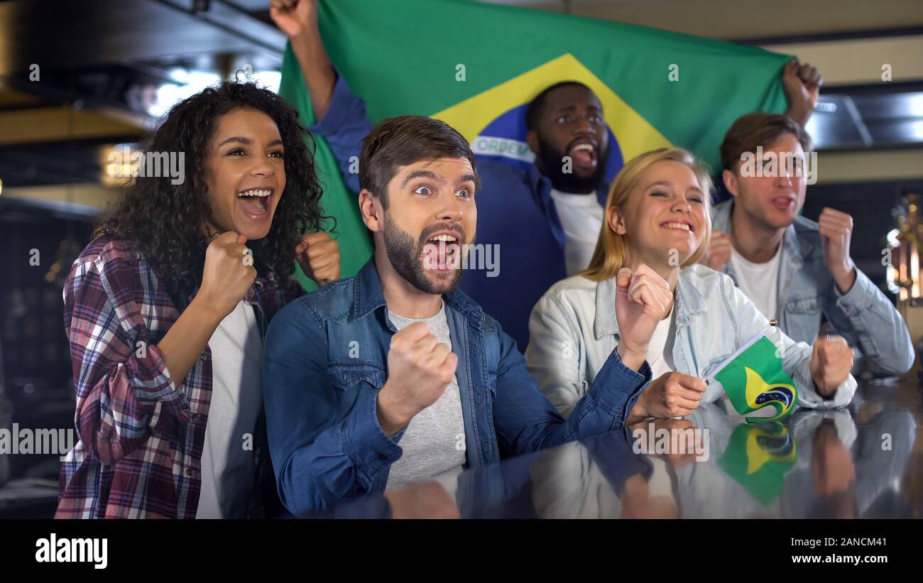 Emotional Brazilian football fans with flags celebrating national team ...