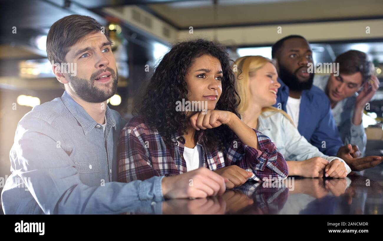 Disappointed team supporters watching championship together, fans ...