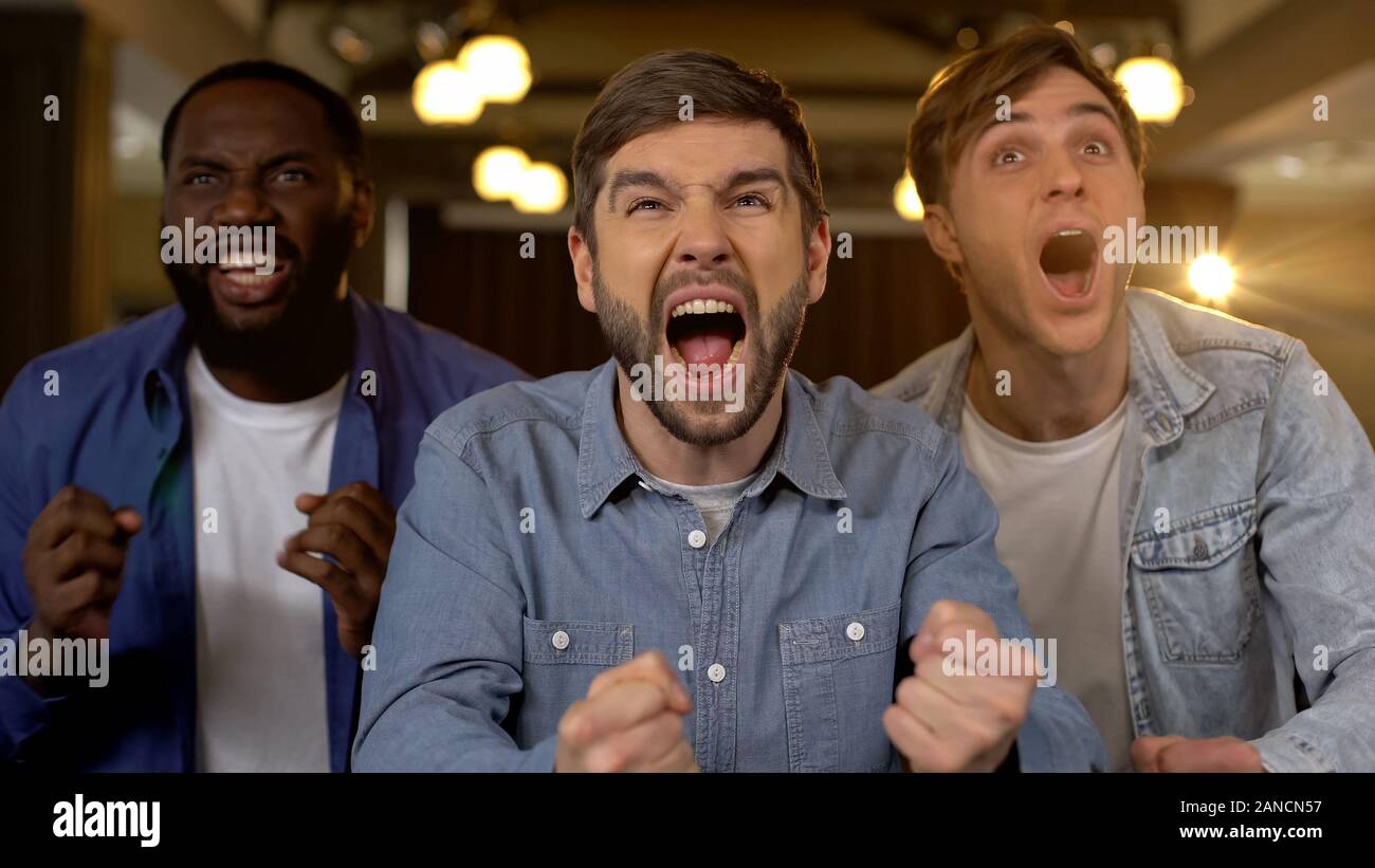 Happy friends watching game, celebrating goal together, excitement ...