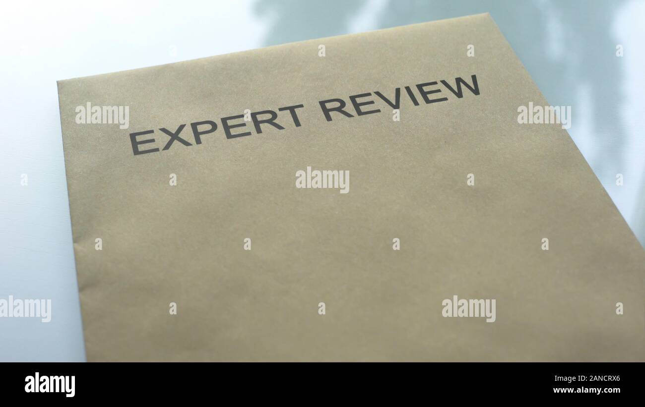 Expert review, folder with important documents lying on table ...