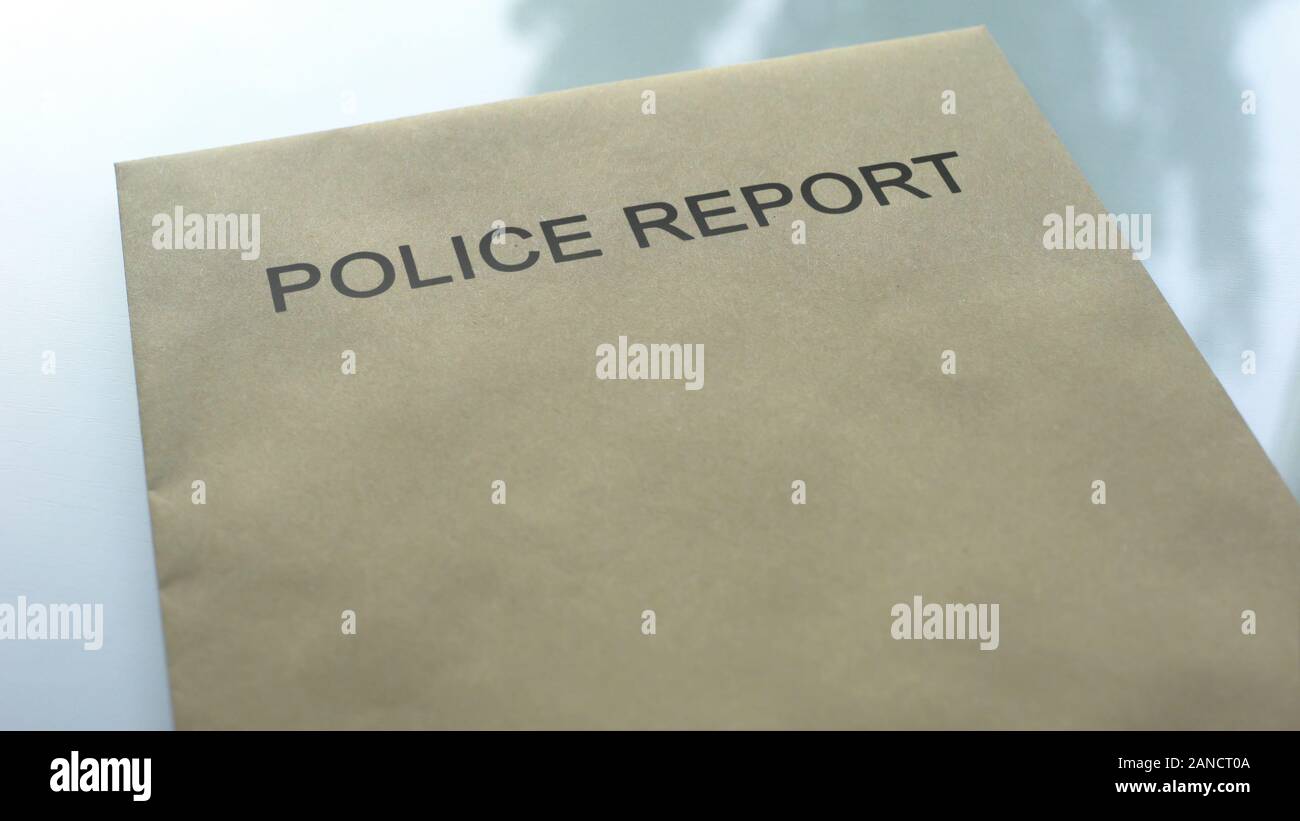 Police report, folder with important documents lying on table ...