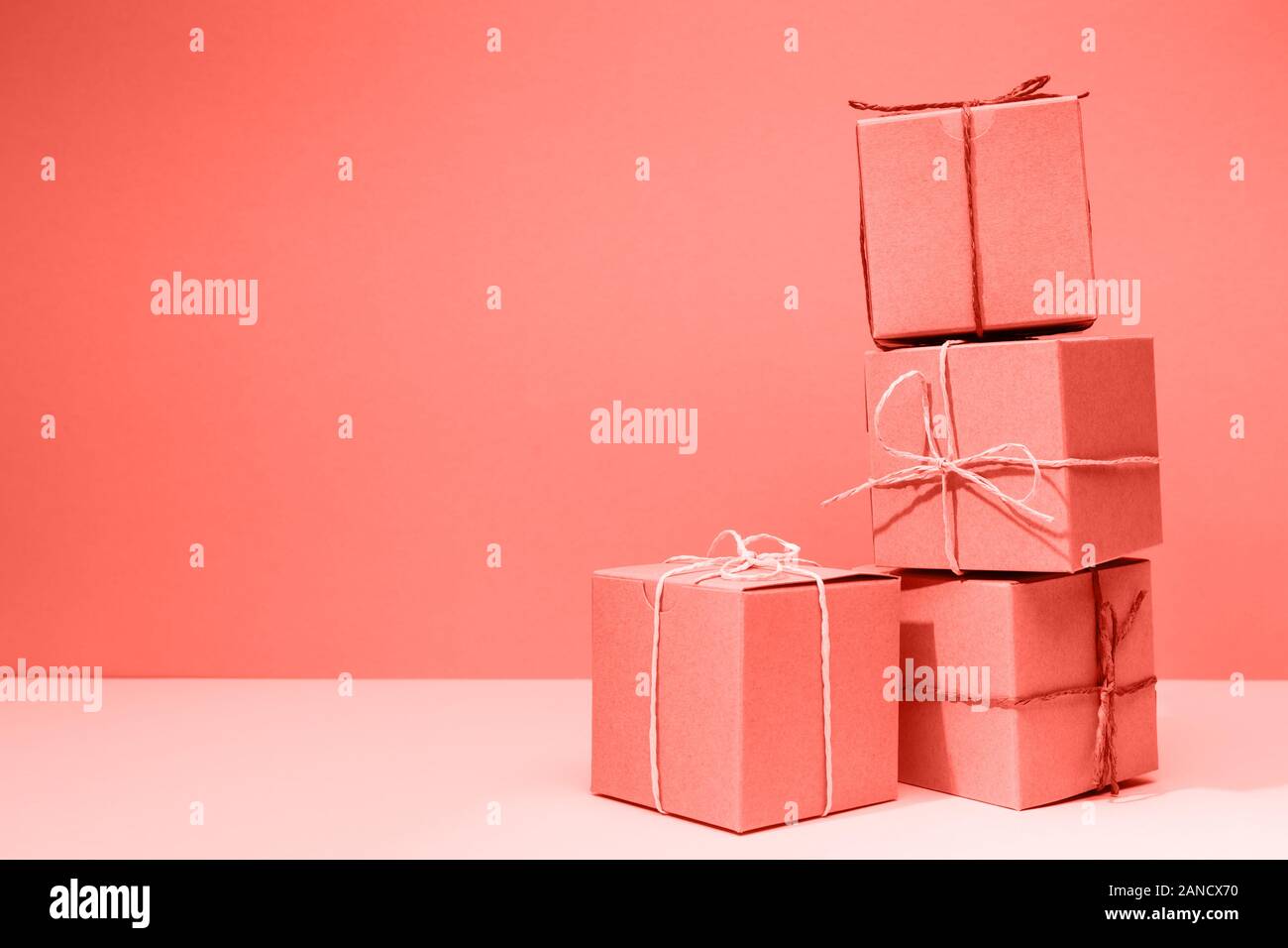 Craft cardboard boxes on the solid pink background. Holiday and gift ...
