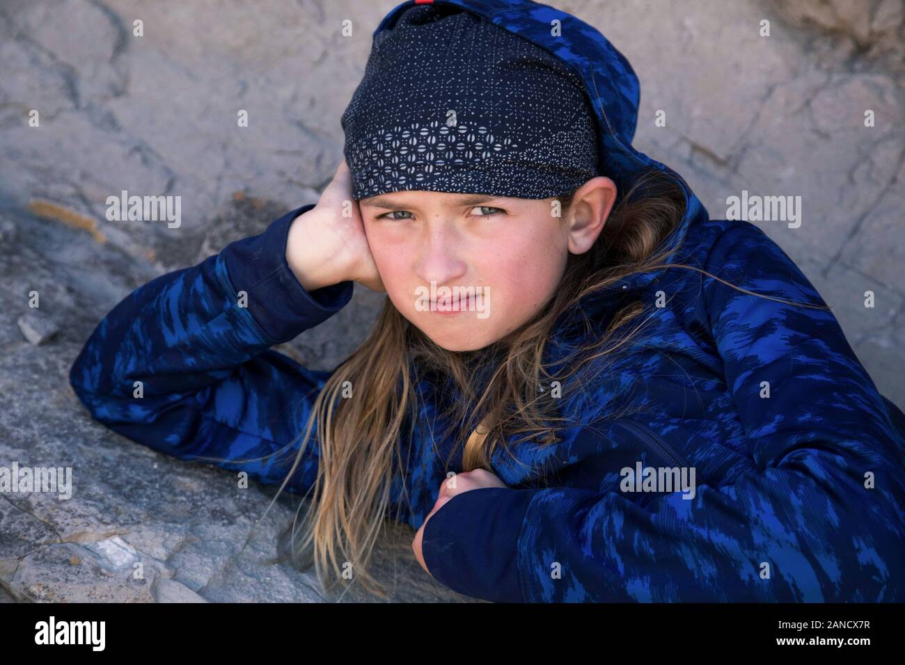 boy laying on rocks looking directly into camera Stock Photo - Alamy