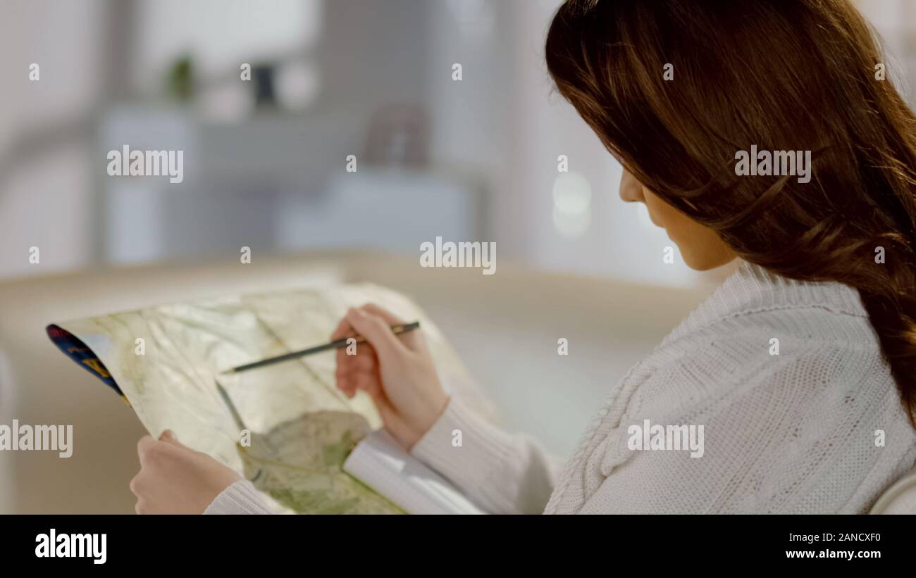 Female looking for place on map, planning road trip with tourist ...