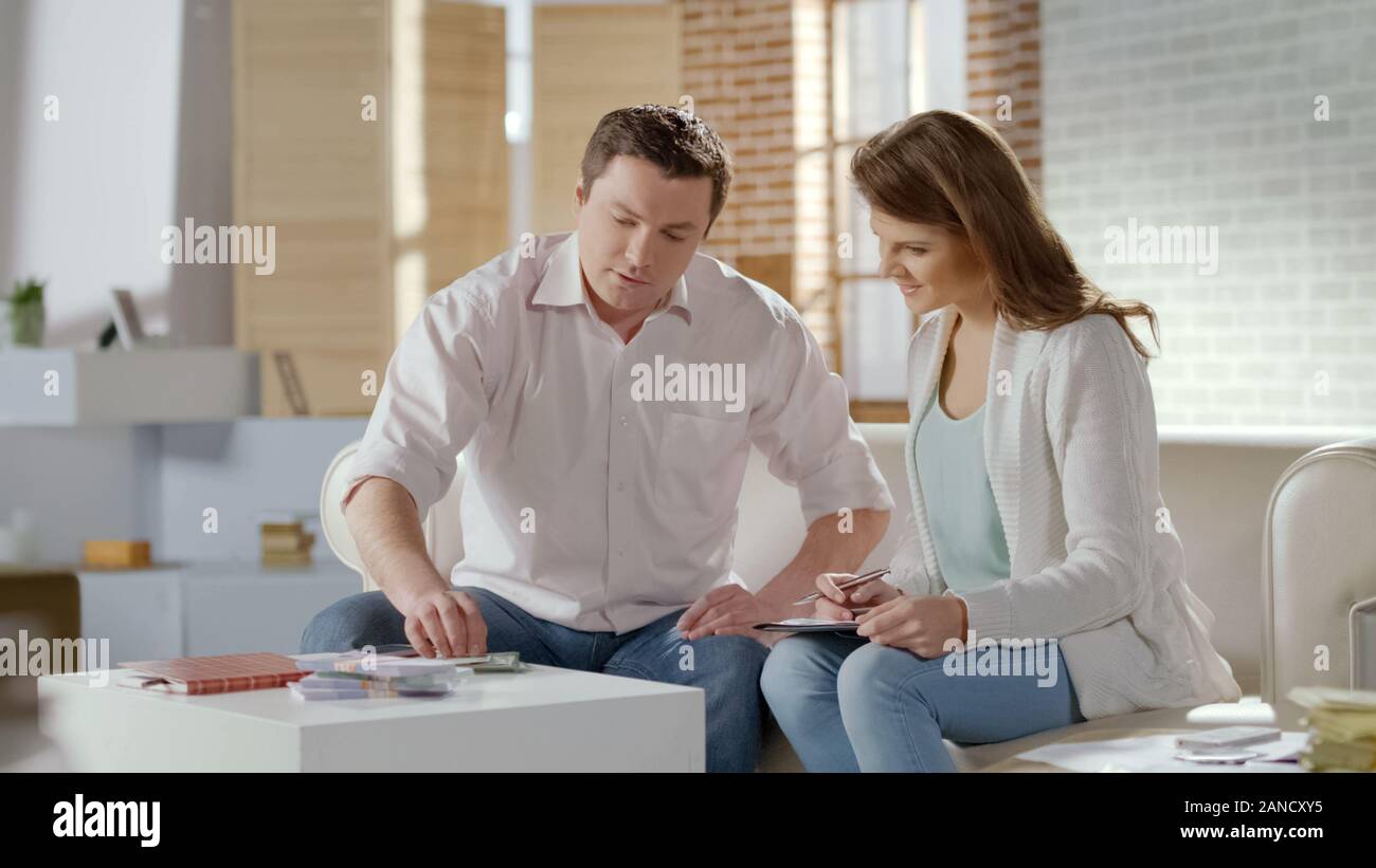 Young rich couple counting lot money, providing business together ...