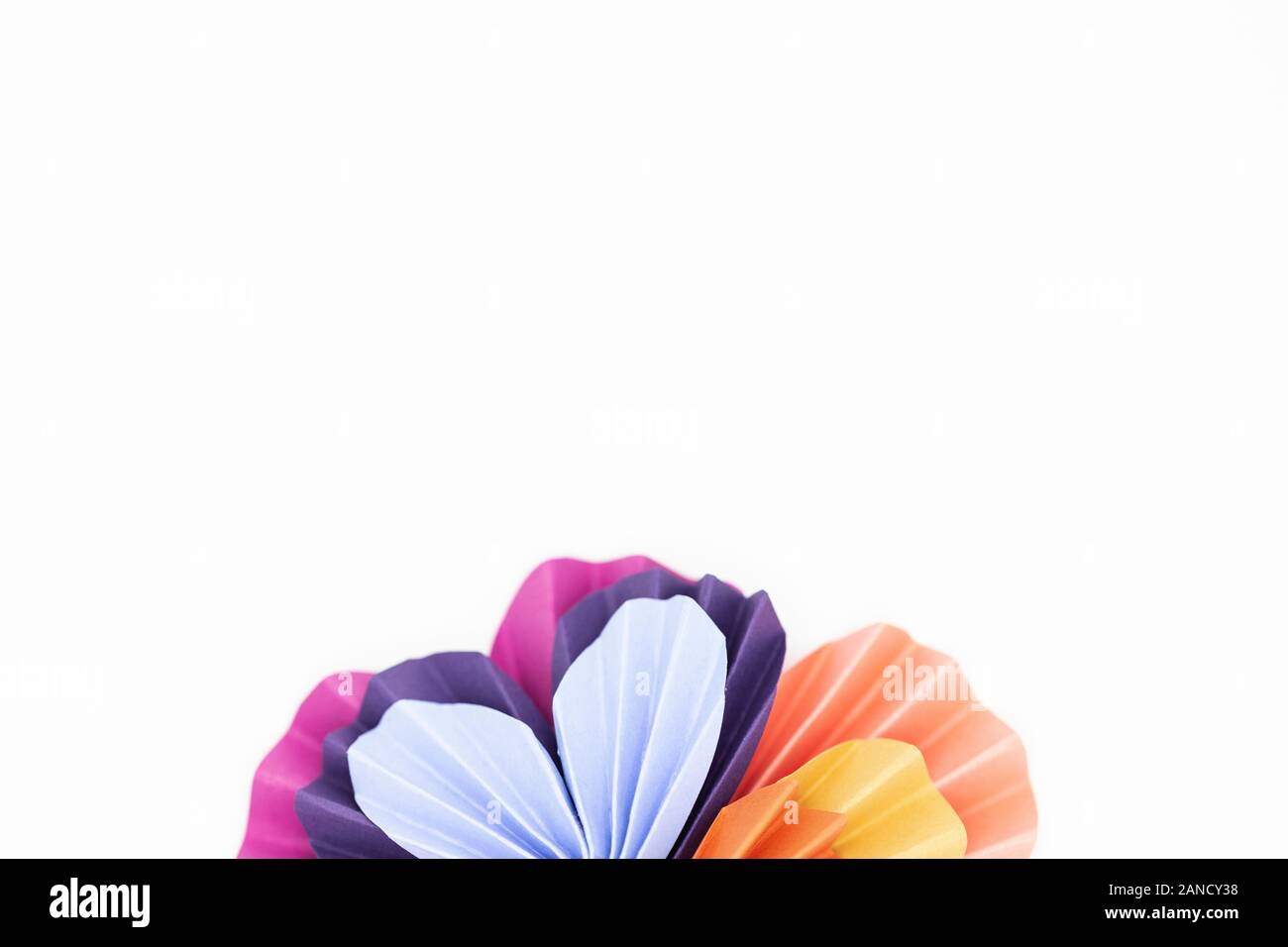 Colorful origami paper hearts folded and arranged into flower shape ...