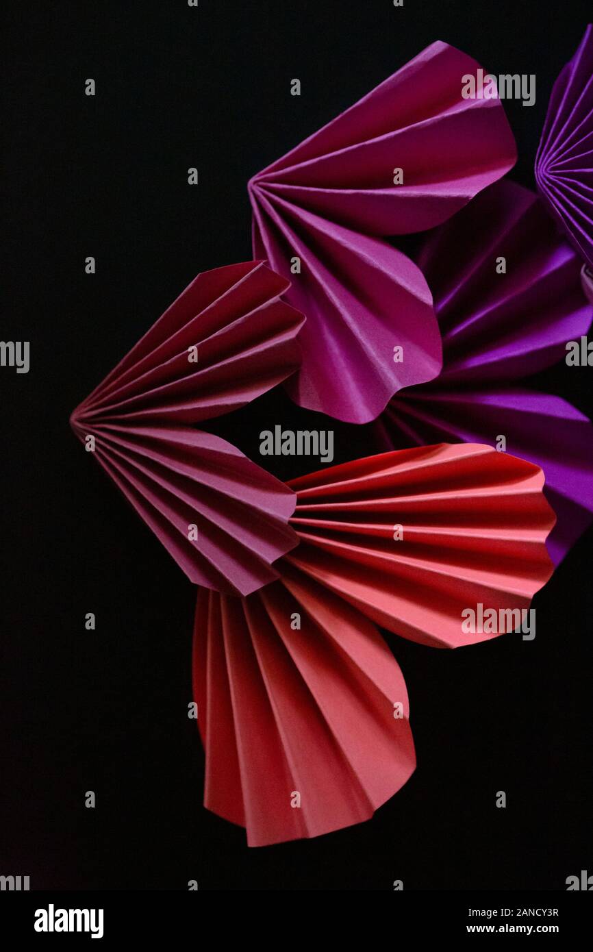 Pink and purple origami paper hearts against black background Stock ...