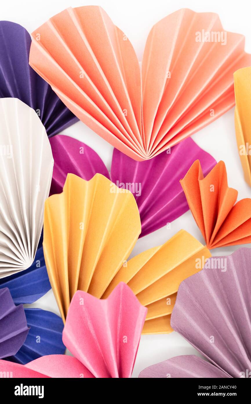 Many homemade colorful paper hearts arranged on white background Stock ...